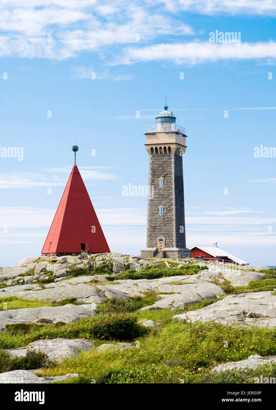 Lighthouse on rocky coast Stock Photo - Alamy