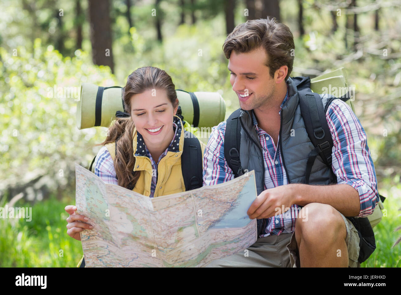 Young couple discussing while looking at map Stock Photo - Alamy