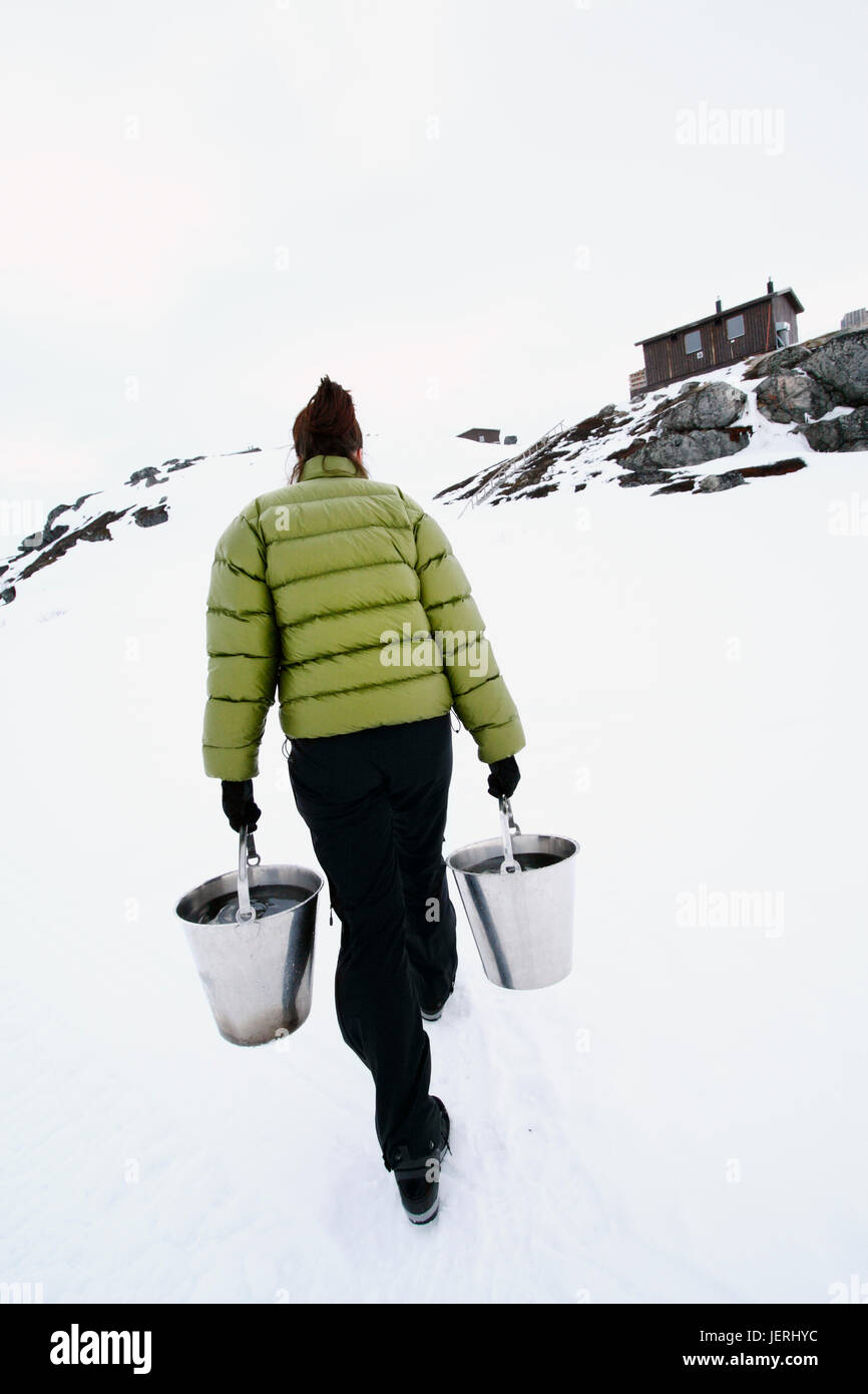 Young woman with buckets at winter Stock Photo - Alamy