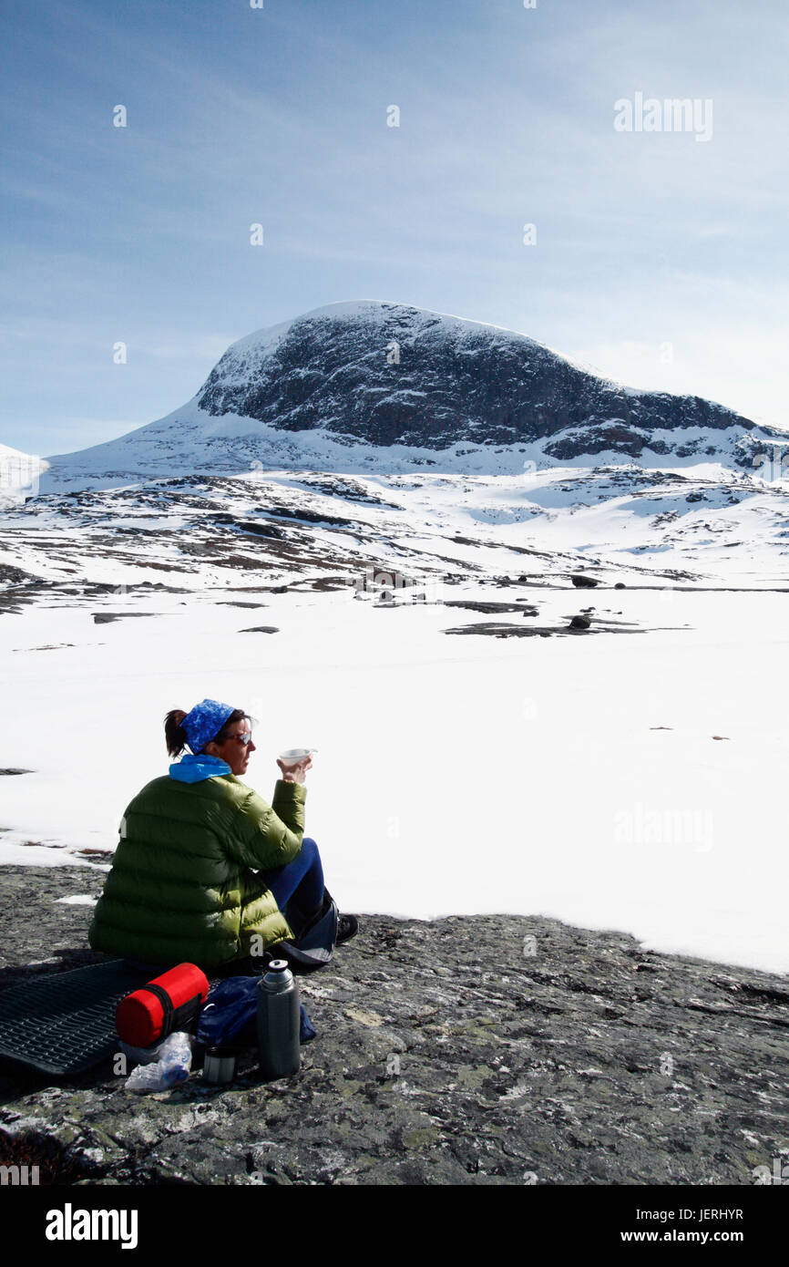 Smiling skier eating Stock Photo - Alamy