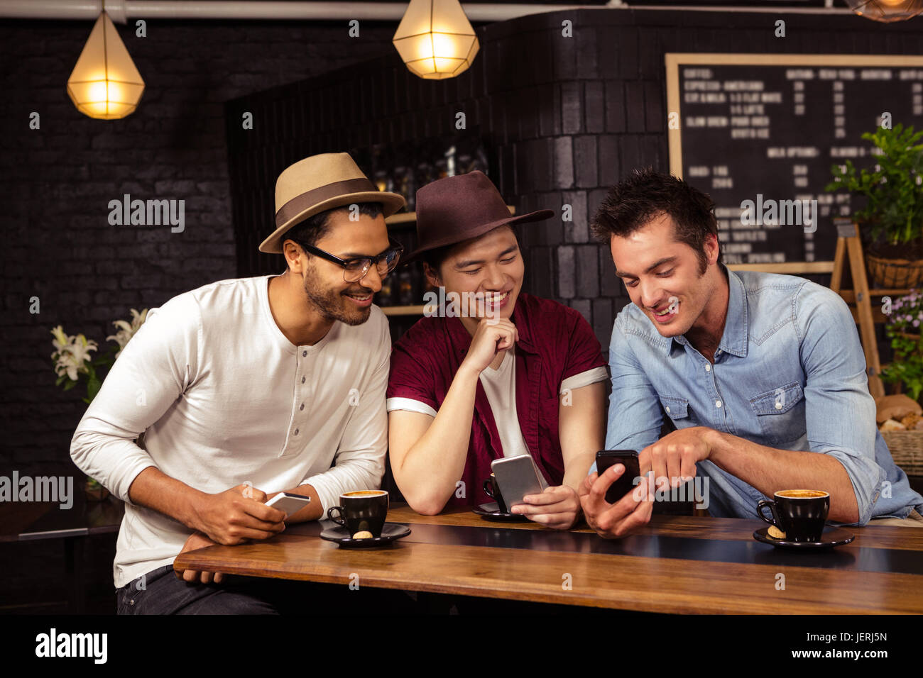 Friends using smartphones Stock Photo - Alamy