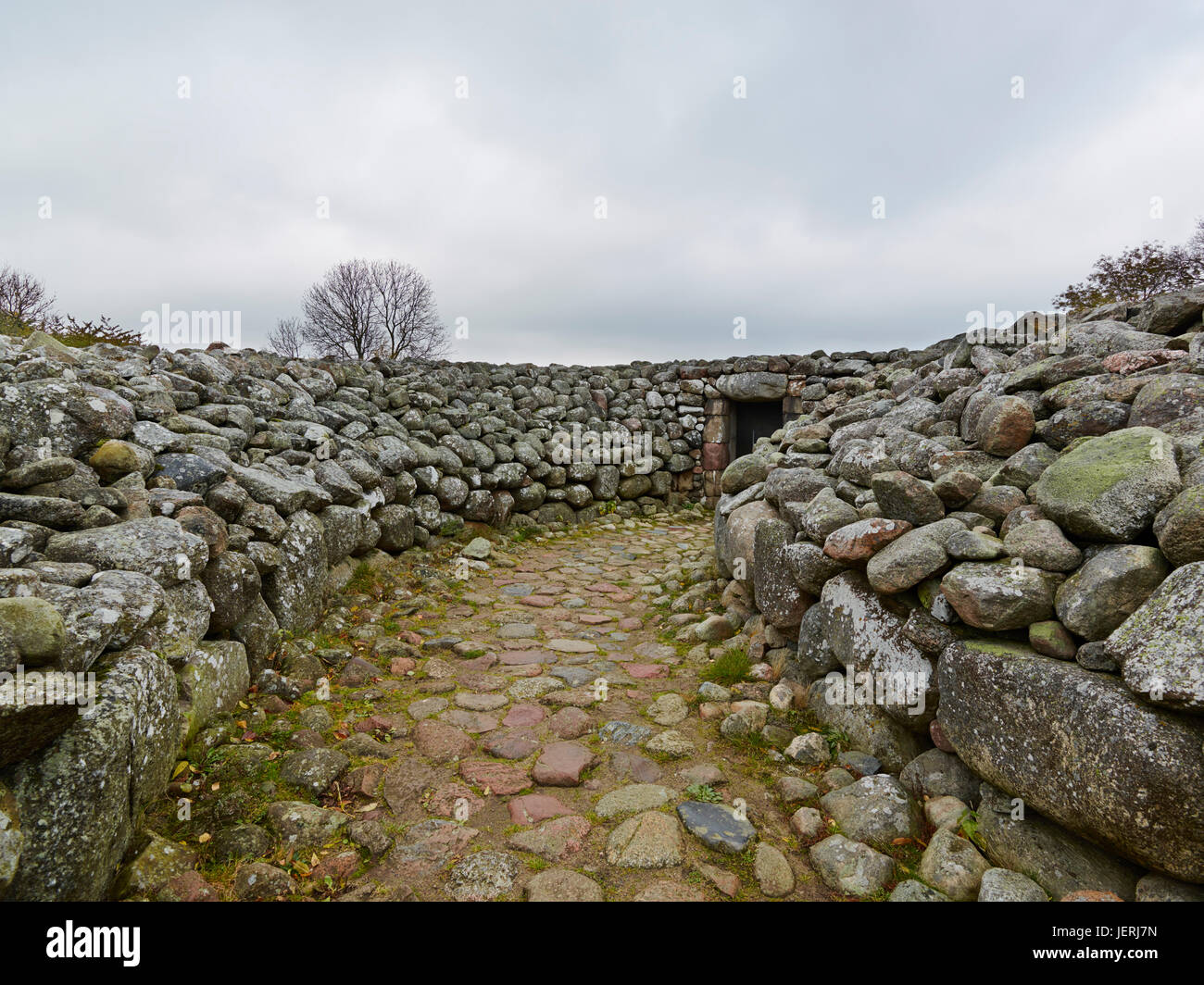 Stone wall along stone path Stock Photo - Alamy