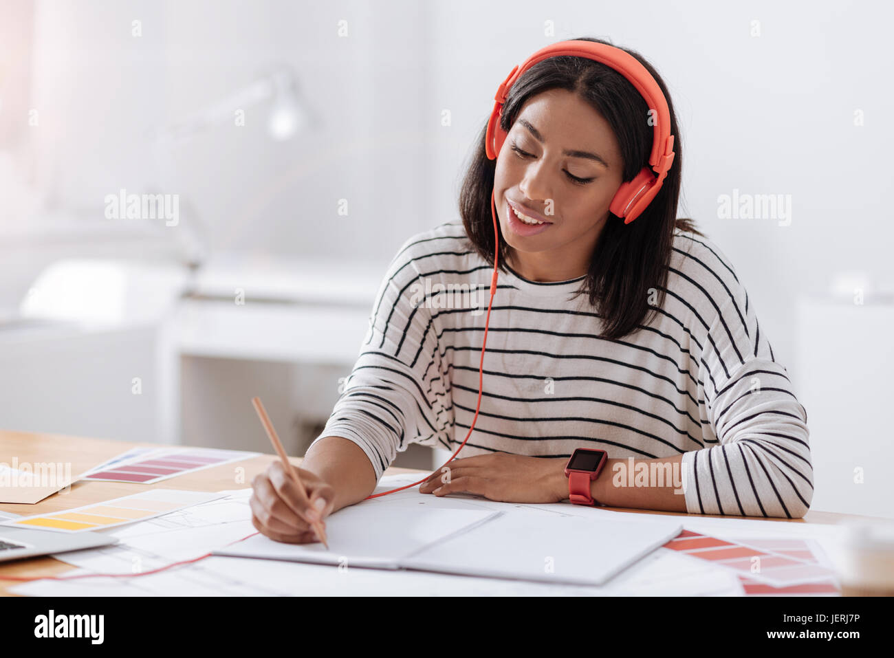 Pleasant young student doing her home task Stock Photo - Alamy