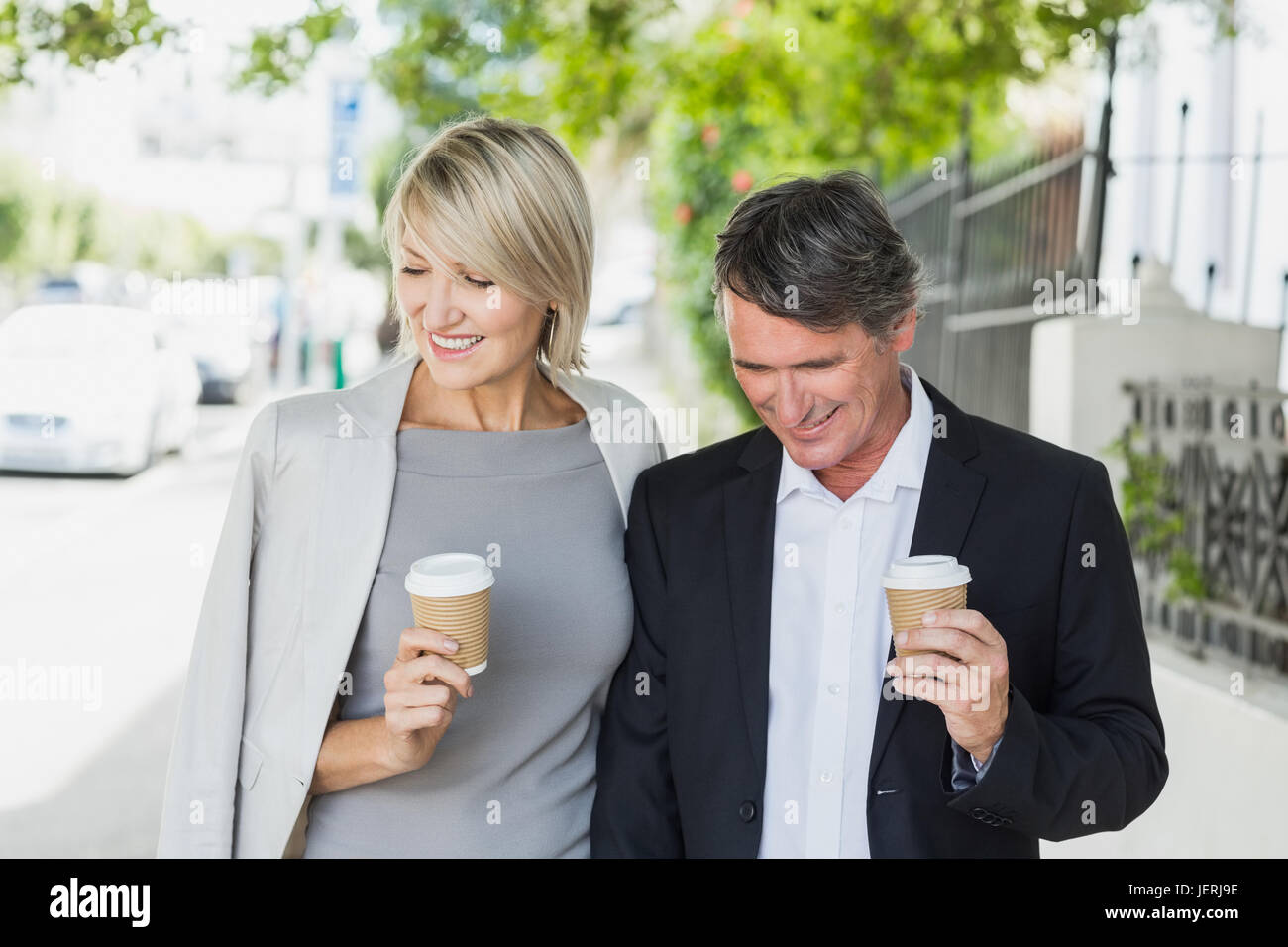 Happy business couple enjoying coffee break Stock Photo - Alamy