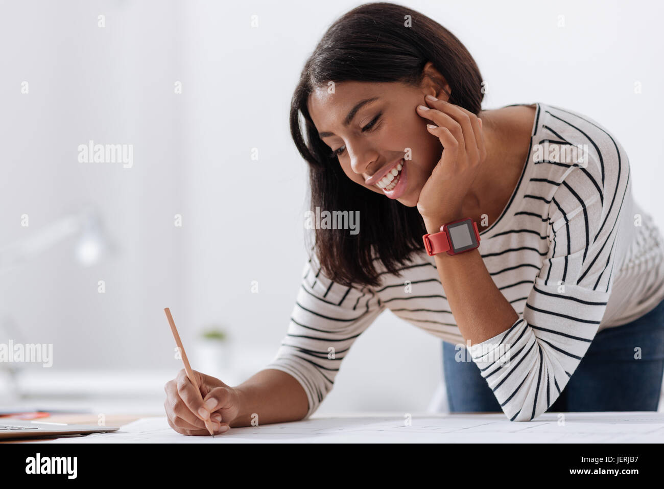 Cheerful delighted woman doing a drawing Stock Photo - Alamy