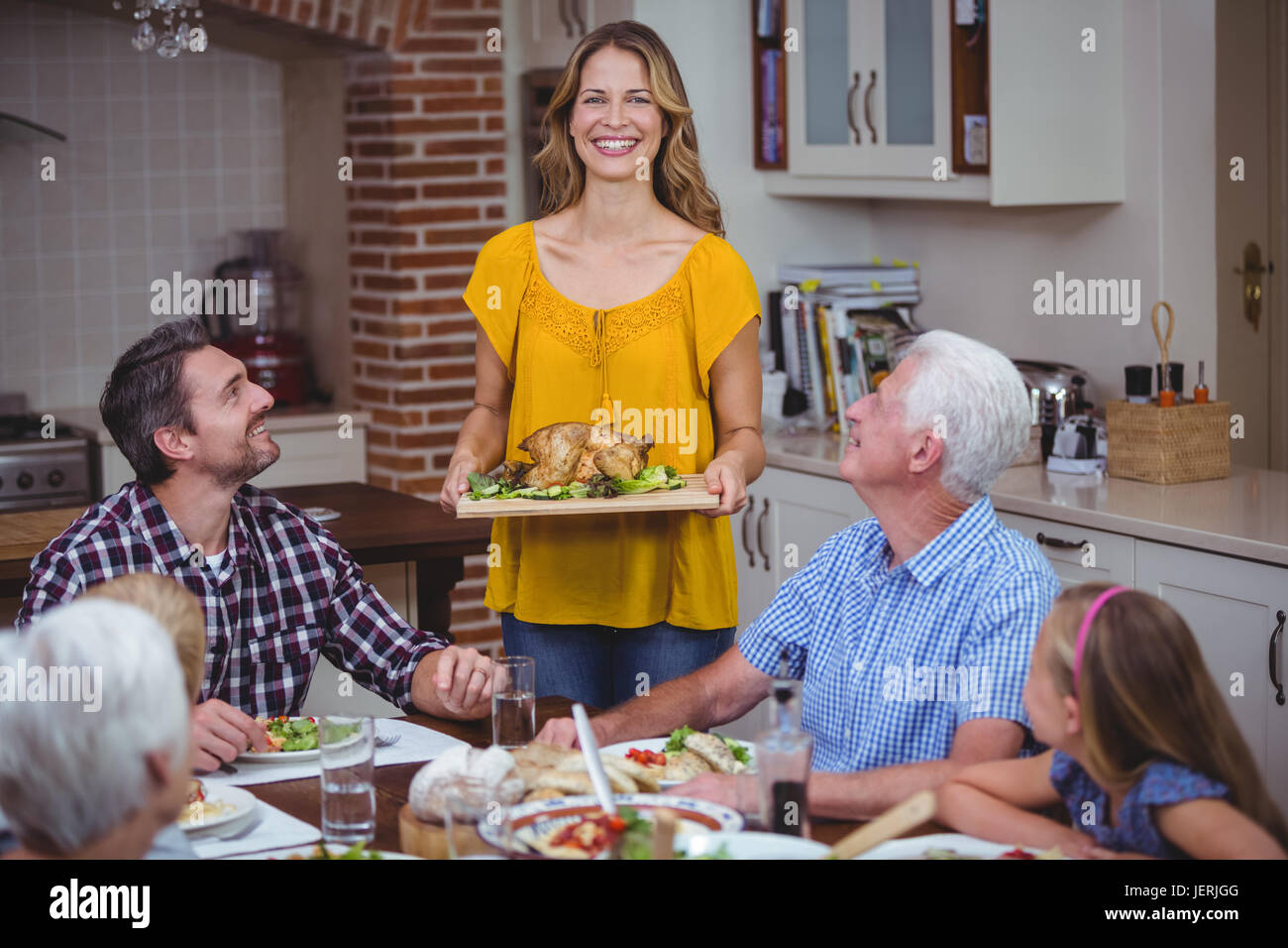 Happy family at dining table with mother Stock Photo - Alamy