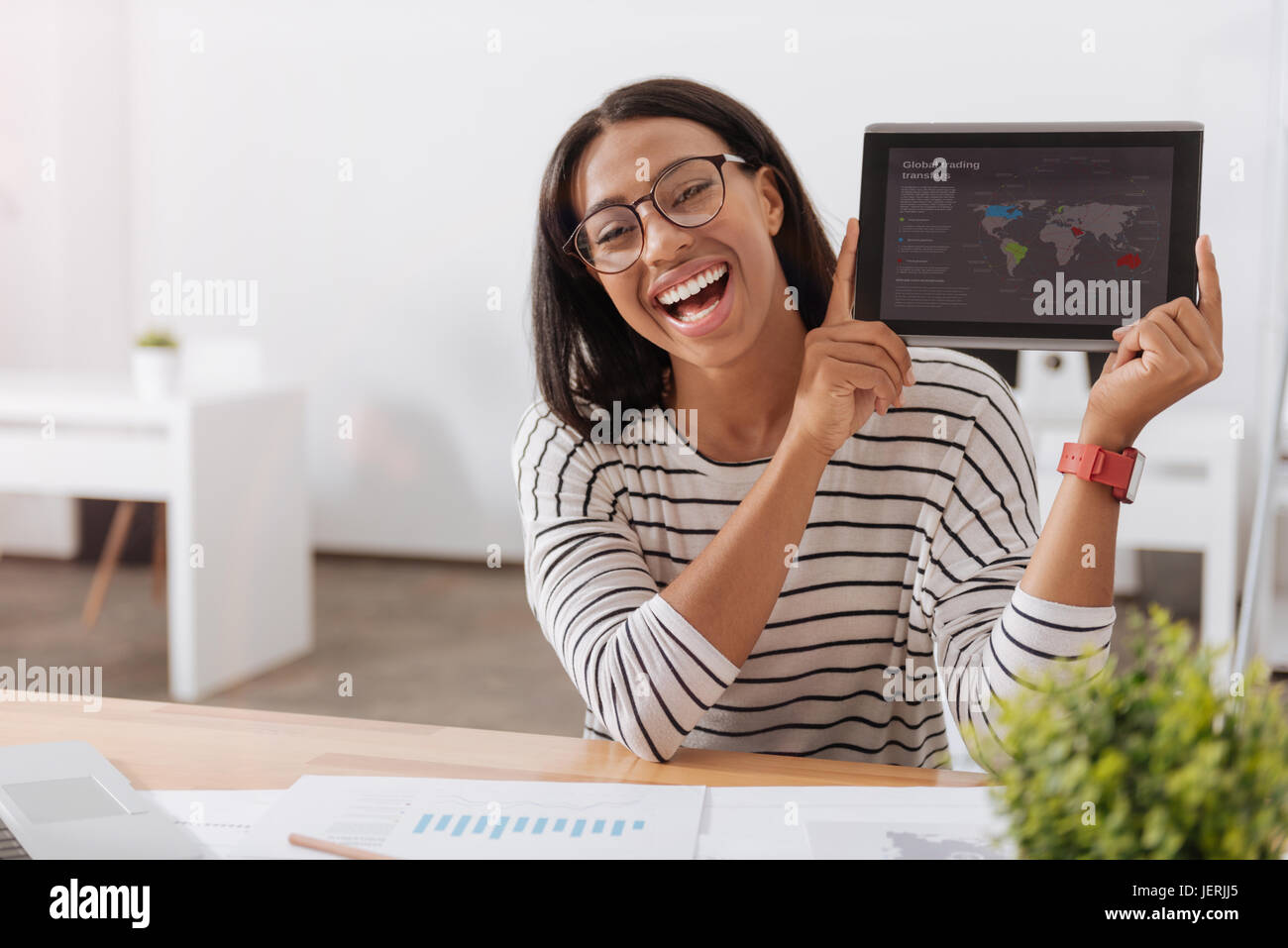Cheerful smart woman showing her work to you Stock Photo - Alamy