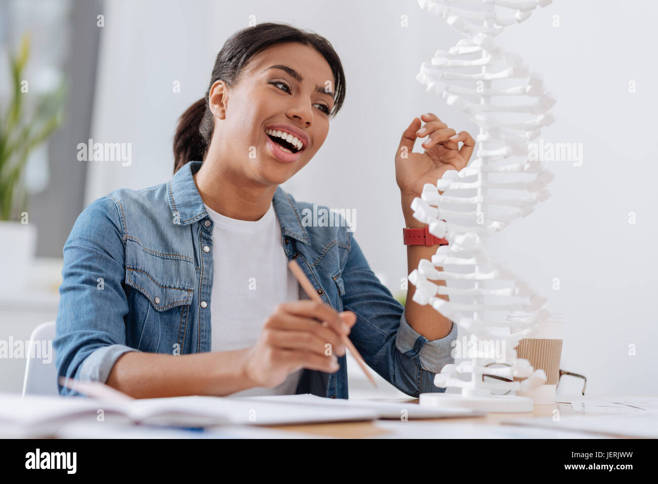 Positive genetic scientist taking notes Stock Photo - Alamy