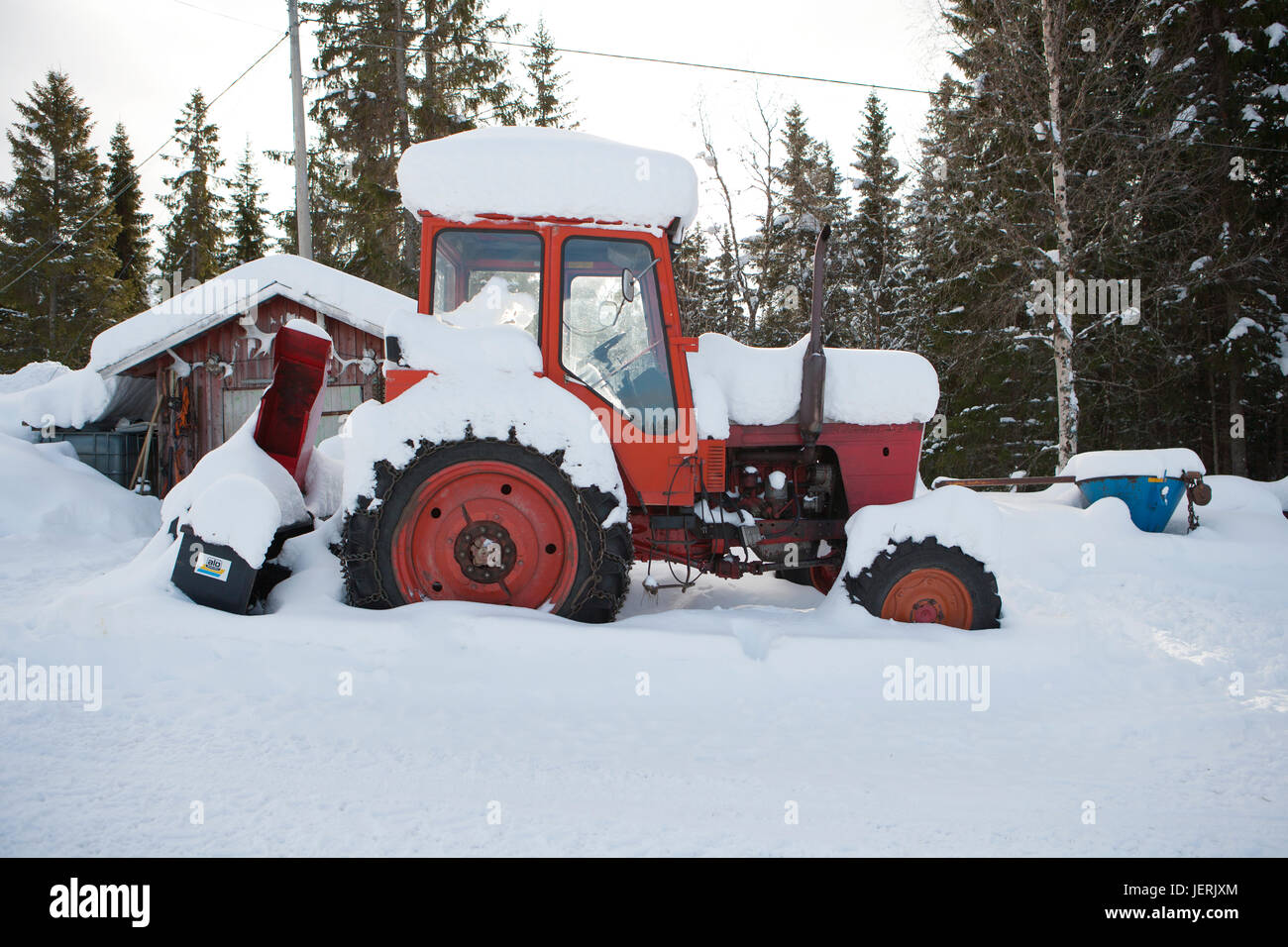 Tractor covered in snow Stock Photo - Alamy