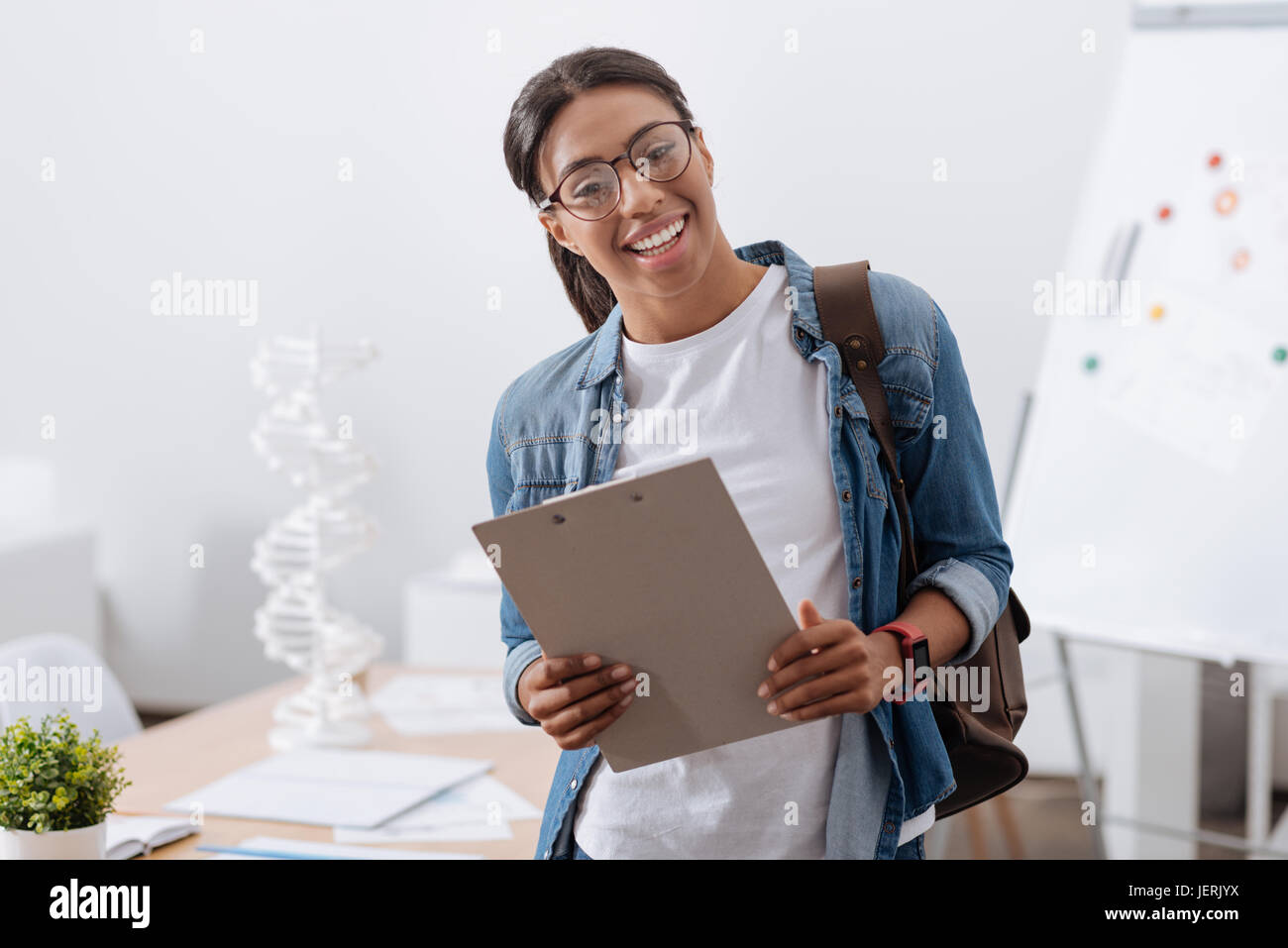 Positive intelligent student holding her notes Stock Photo - Alamy