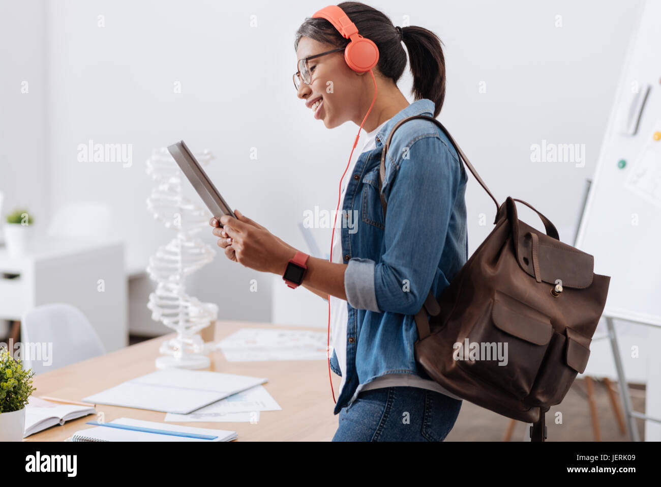 Cheerful nice student listening to music Stock Photo - Alamy