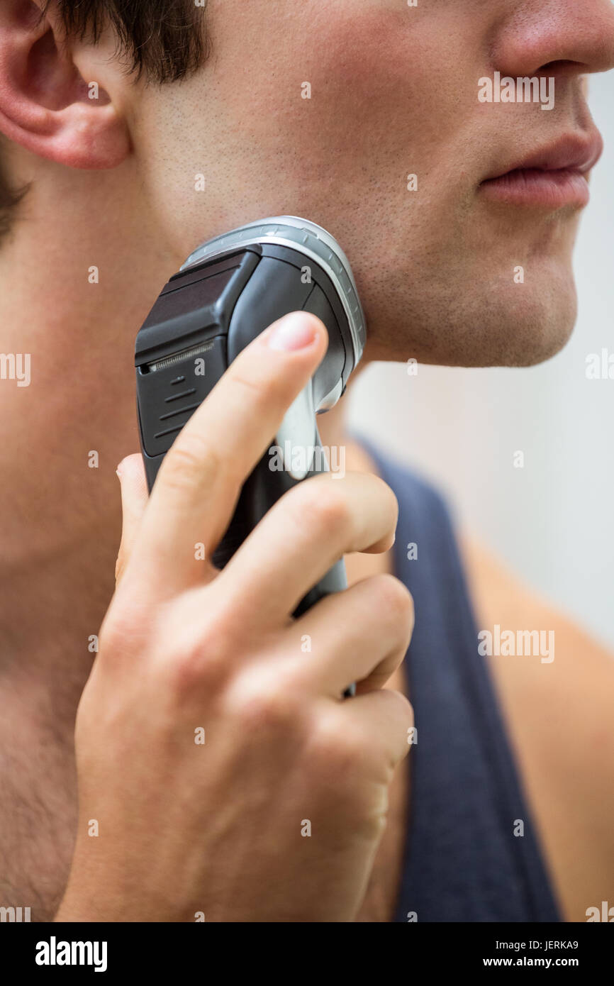 Mid-section of man shaving with trimmer Stock Photo - Alamy