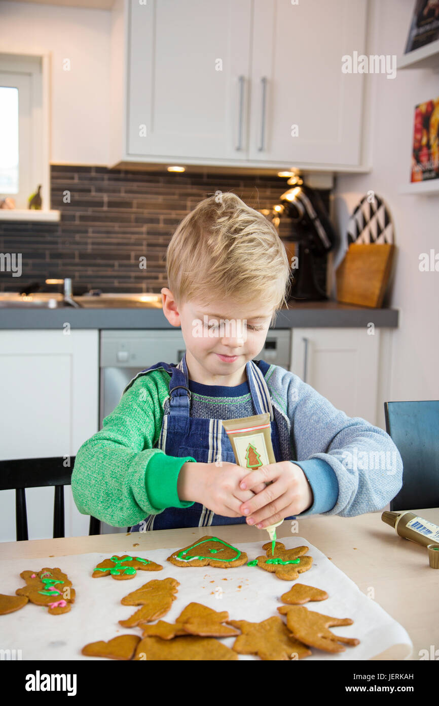 Boy decorating gingerbread hi-res stock photography and images - Alamy