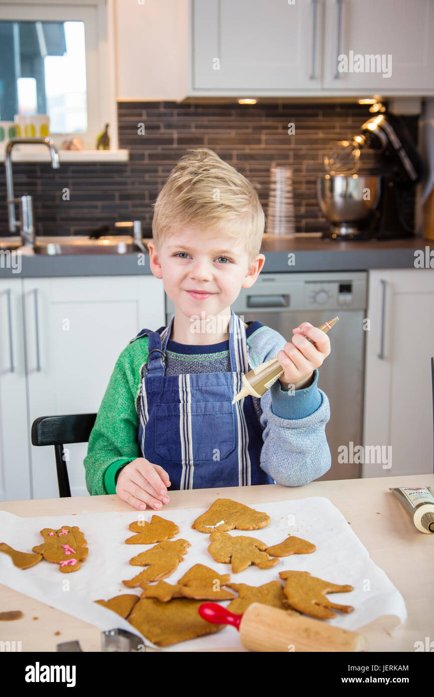 Boy decorating gingerbread hi-res stock photography and images - Alamy