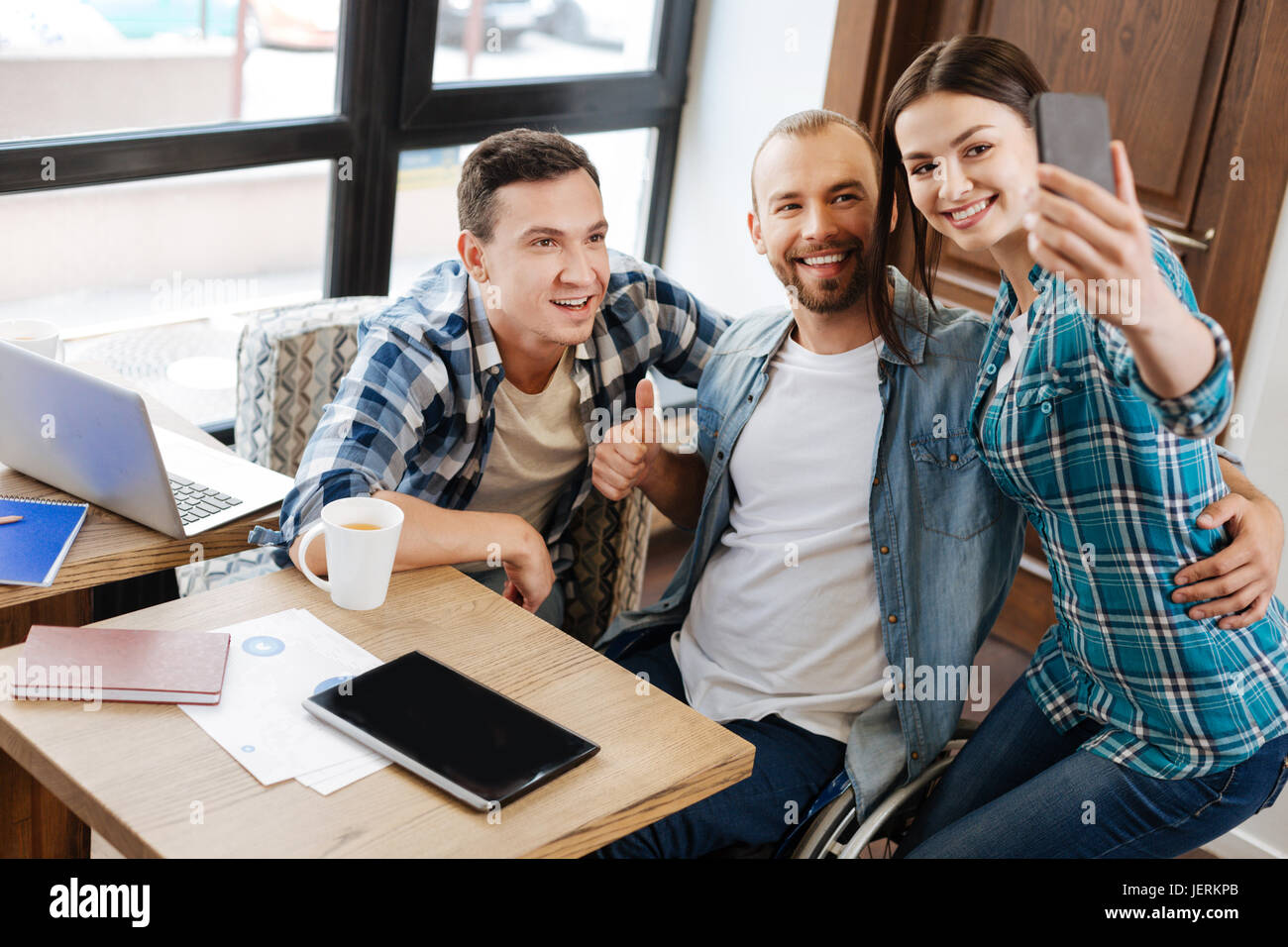 Creative charming friends posing for a picture Stock Photo - Alamy