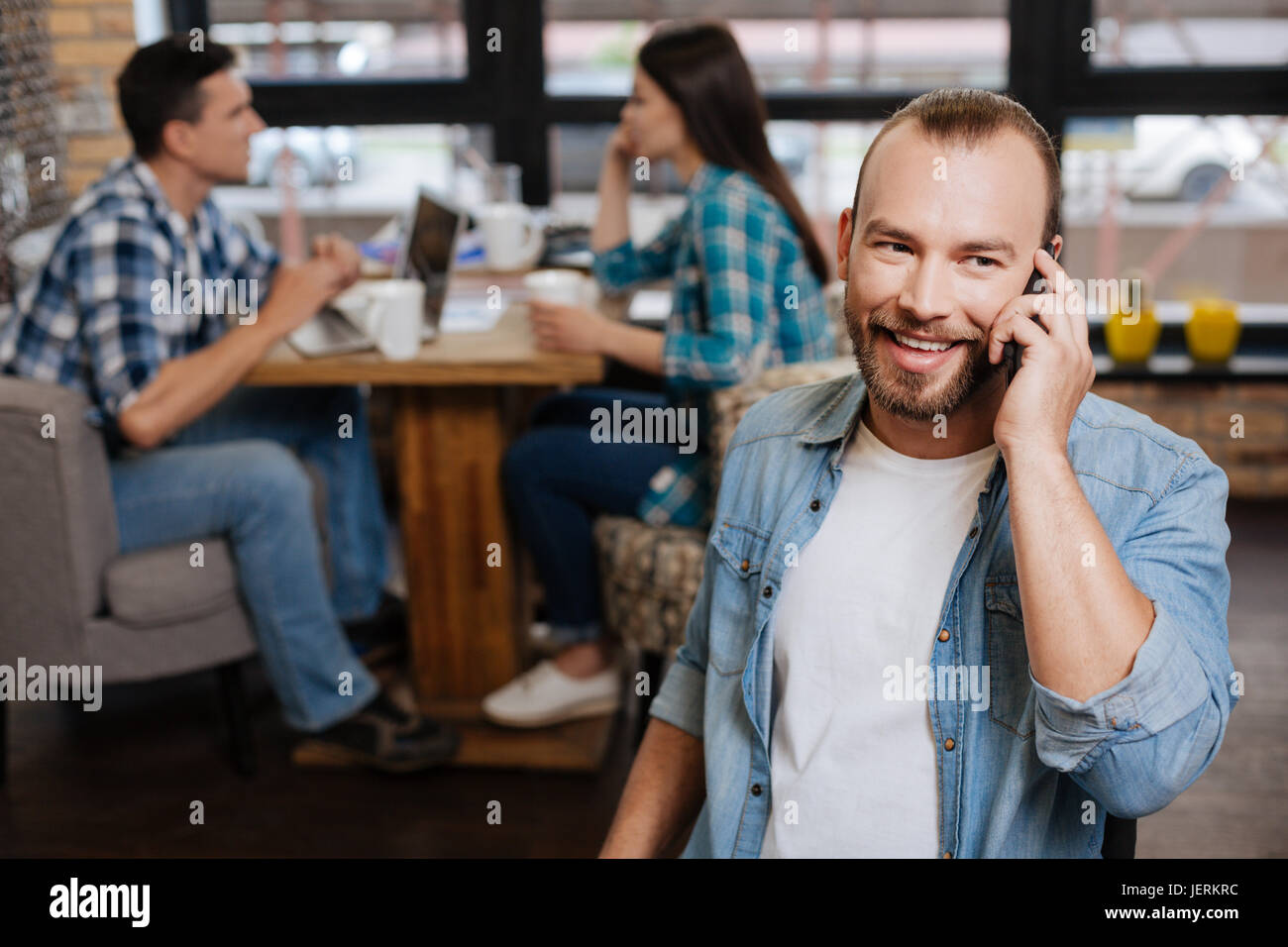 Outgoing sociable guy calling someone Stock Photo - Alamy