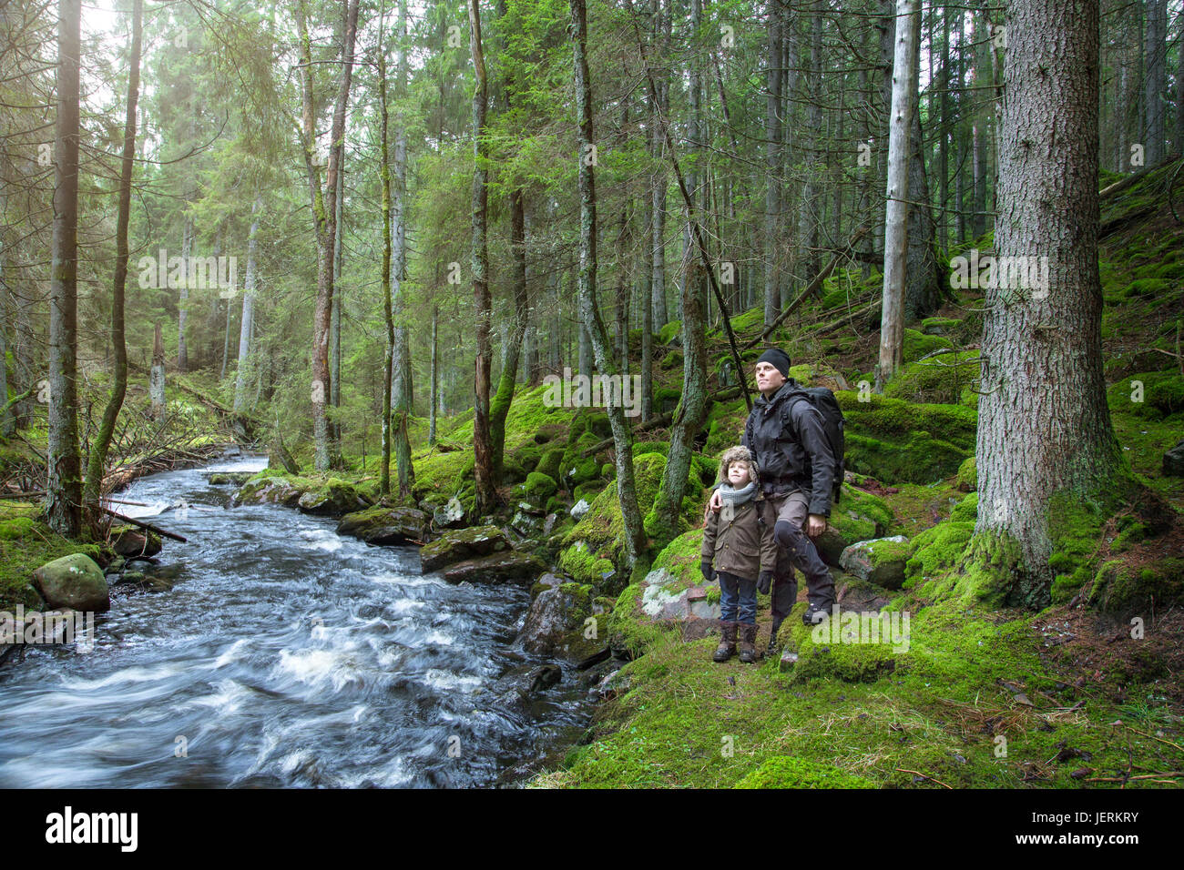 Boy with father in forest Stock Photo - Alamy