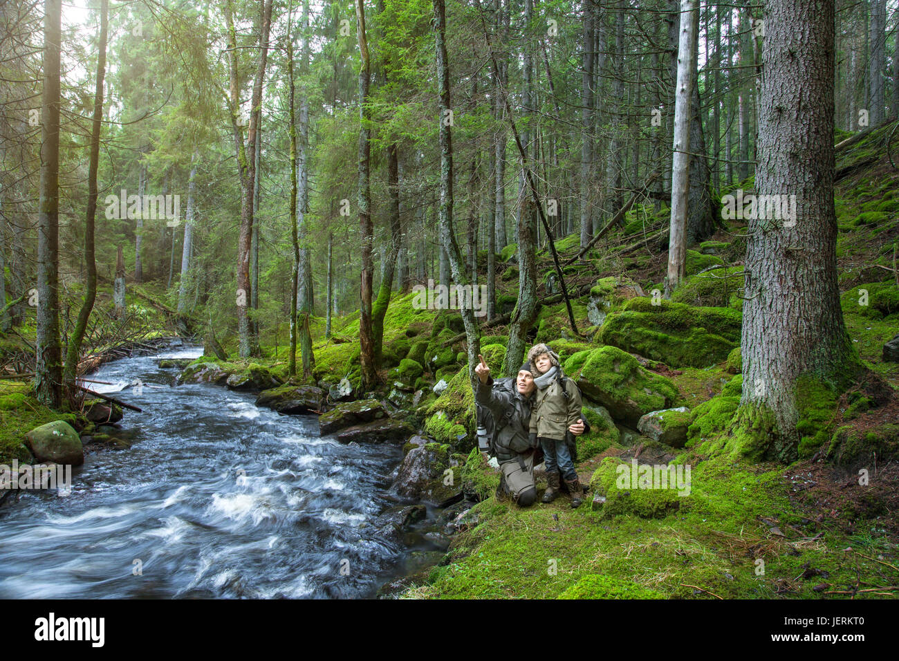 Boy with father in forest Stock Photo - Alamy