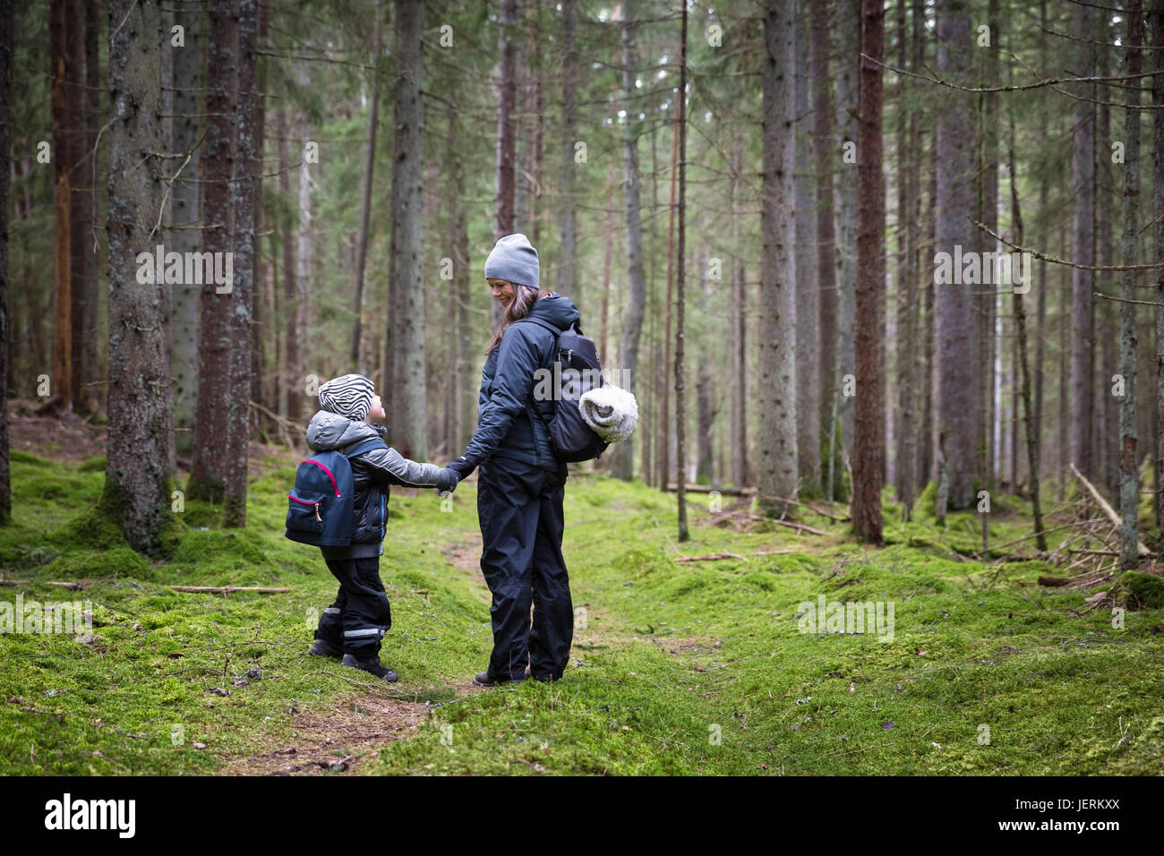 Mother walking with her son in forest hi-res stock photography and ...