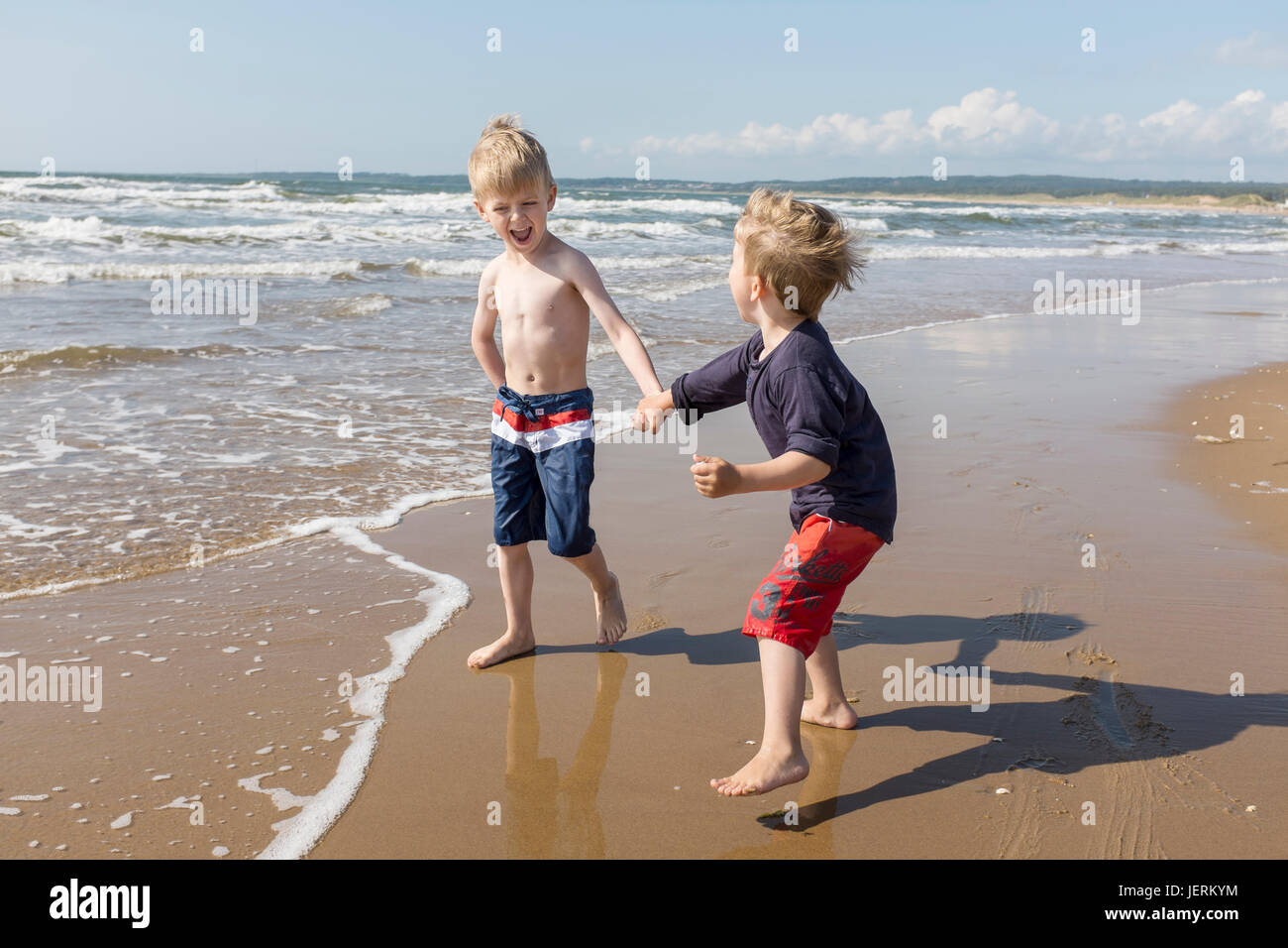 Boys playing on beach Stock Photo - Alamy