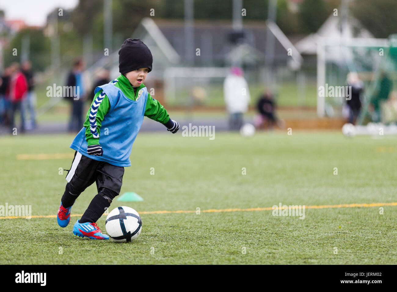 Boy playing football Stock Photo - Alamy