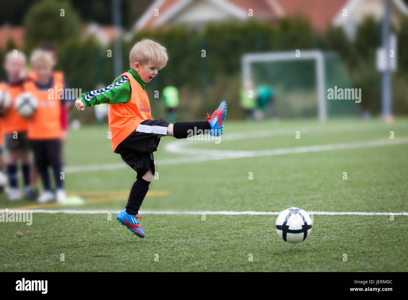 Boy playing football Stock Photo - Alamy
