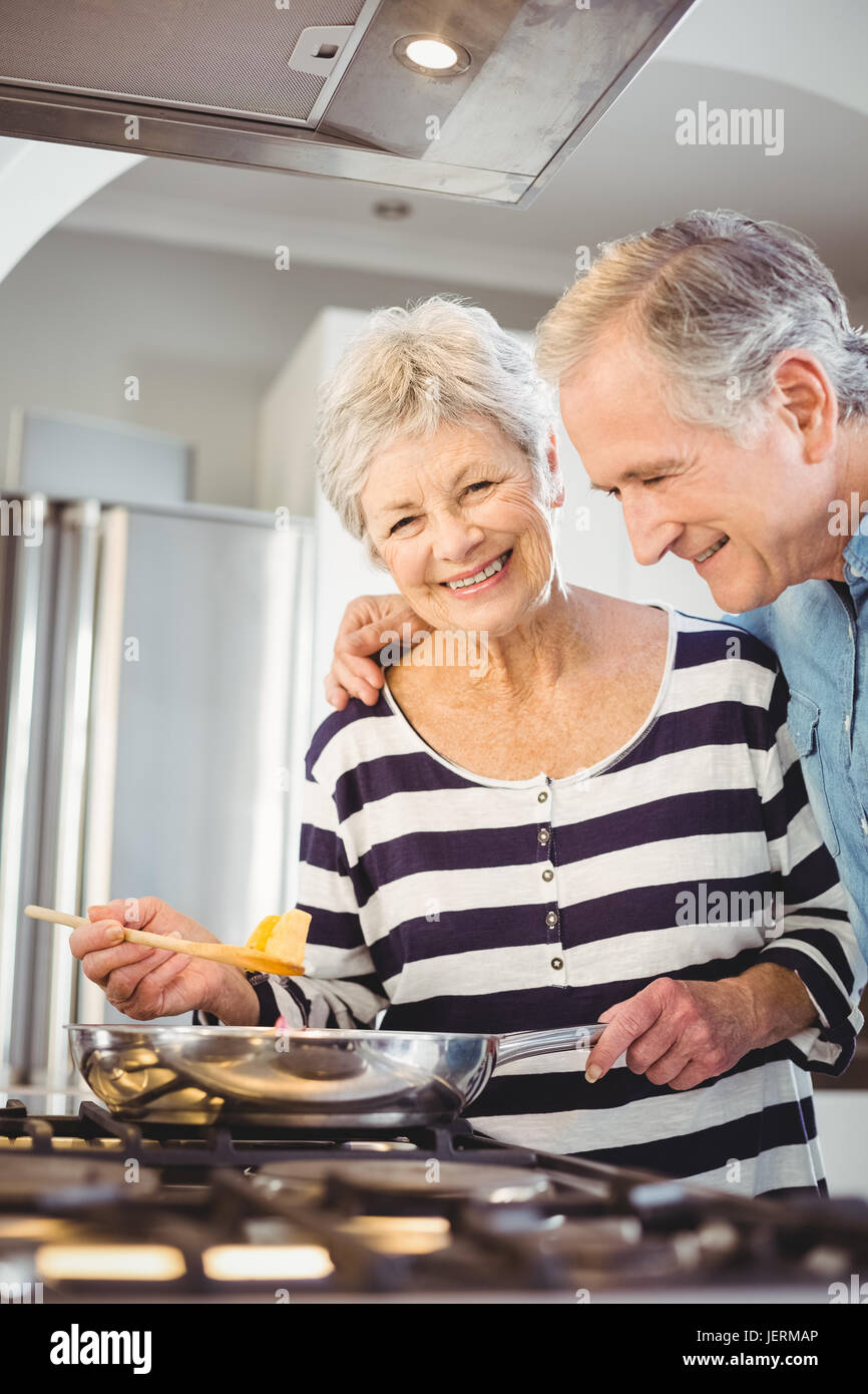 Happy senior couple cooking food in kitchen Stock Photo - Alamy