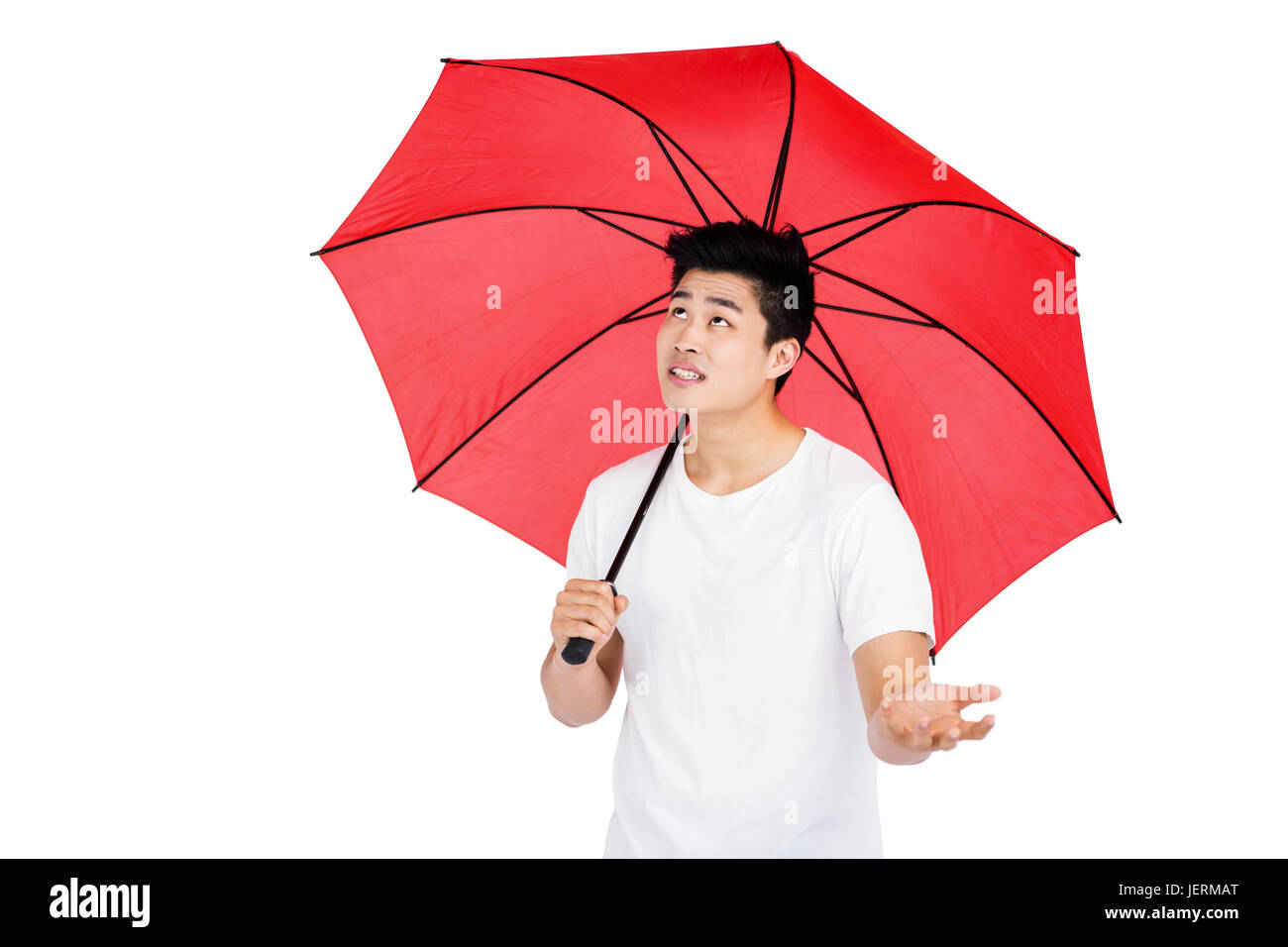 Young man holding umbrella Stock Photo - Alamy