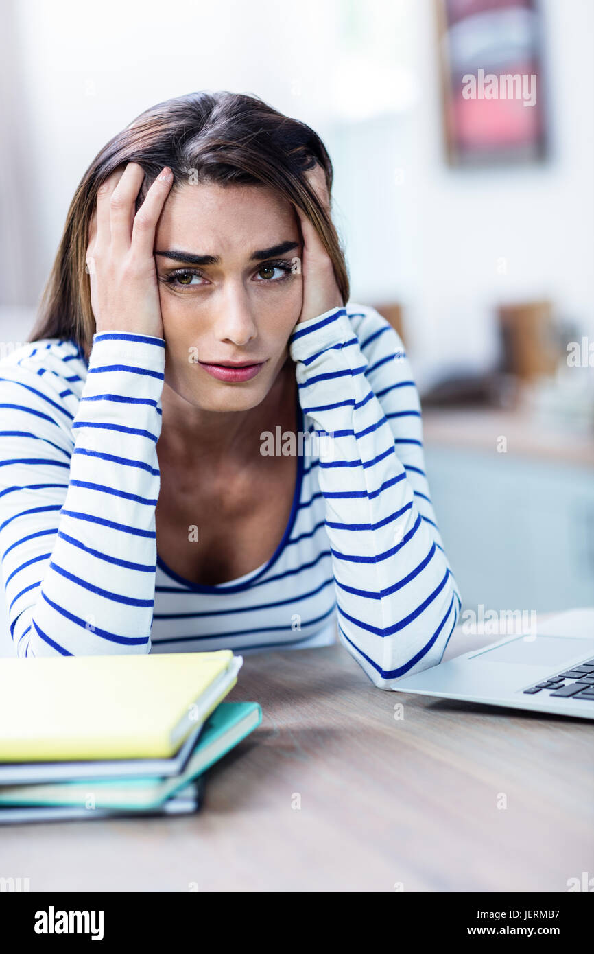Close-up of tensed woman with head in hands Stock Photo - Alamy