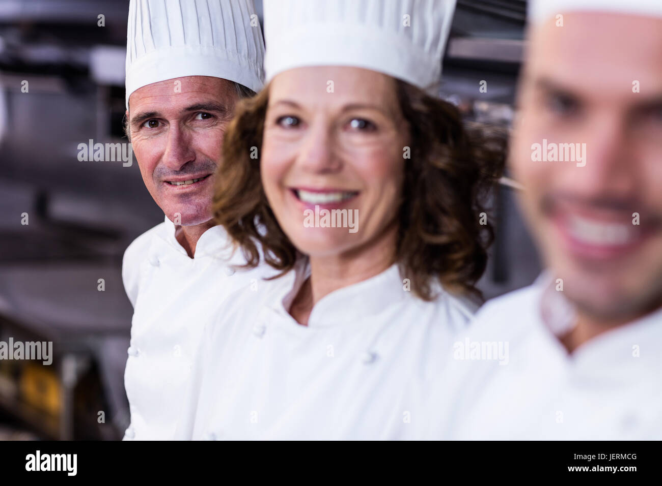 Group of happy chefs smiling at the camera Stock Photo - Alamy