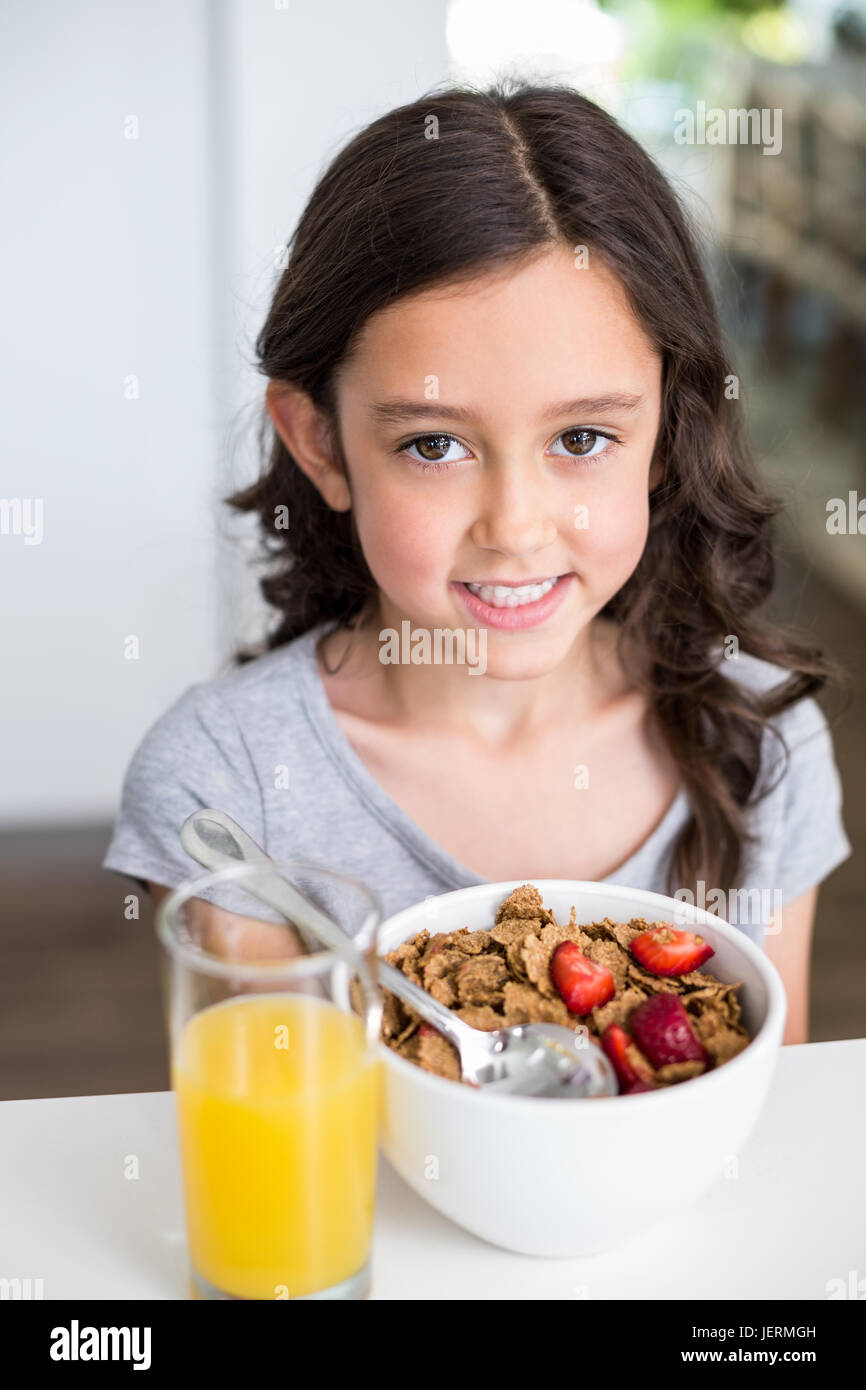 Smiling girl having breakfast Stock Photo - Alamy