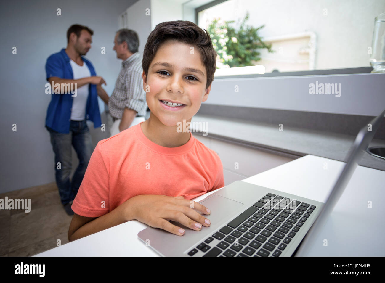 Happy boy using laptop Stock Photo - Alamy