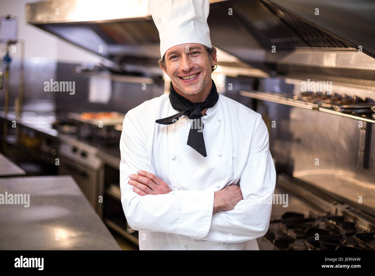 Handsome chef leaning on counter Stock Photo - Alamy