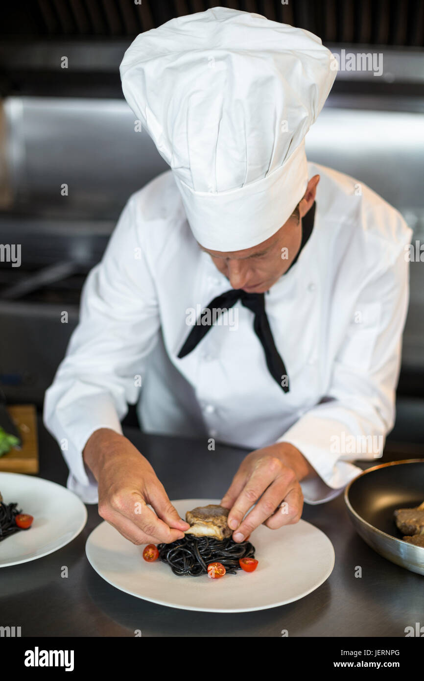 Chef preparing food in kitchen Stock Photo - Alamy