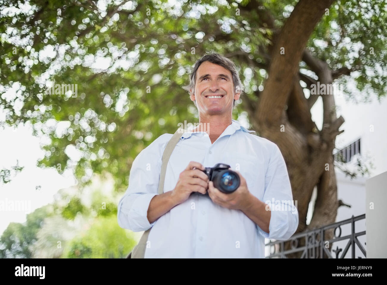 Happy man with camera Stock Photo - Alamy