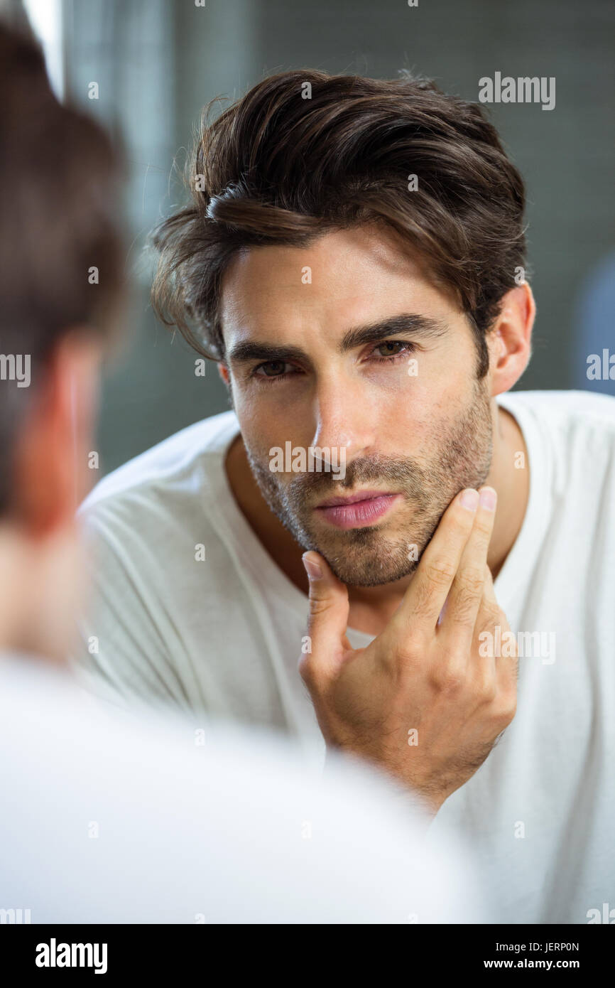 Man checking his stubble in bathroom Stock Photo - Alamy