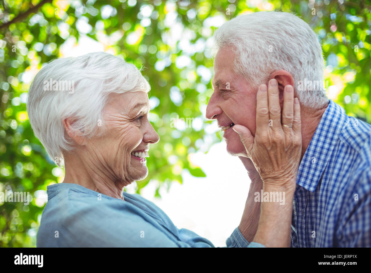 Romantic couple standing face to face Stock Photo - Alamy