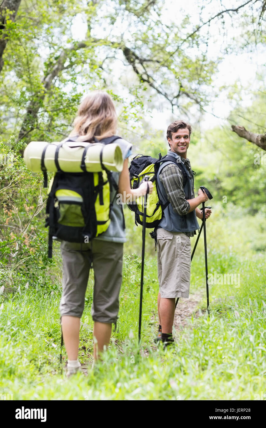 Smiling man looking at partner while hiking Stock Photo - Alamy