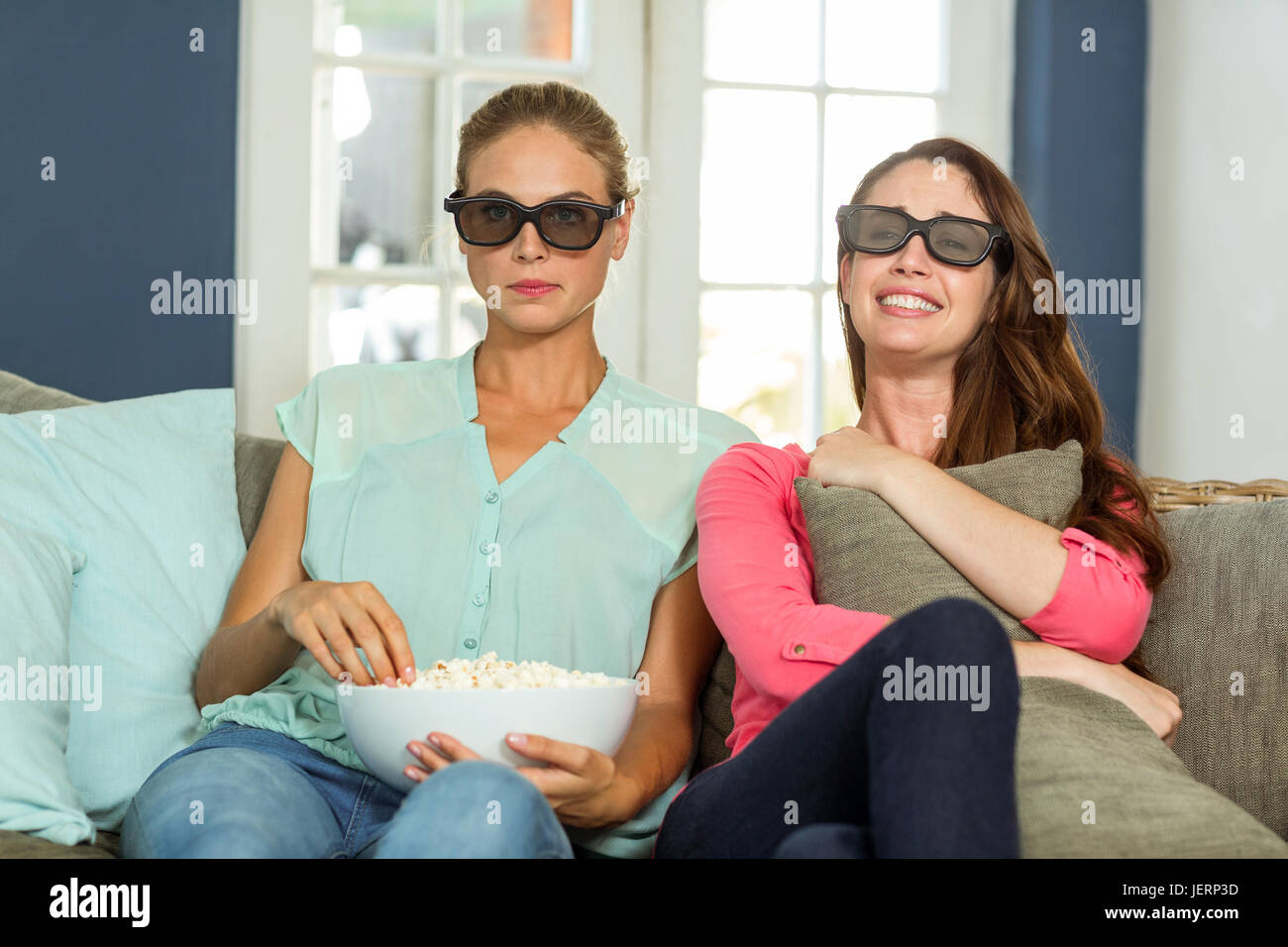 Female friends watching movie Stock Photo - Alamy
