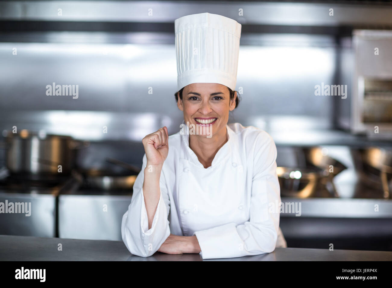 Portrait of smiling female chef in kitchen Stock Photo - Alamy