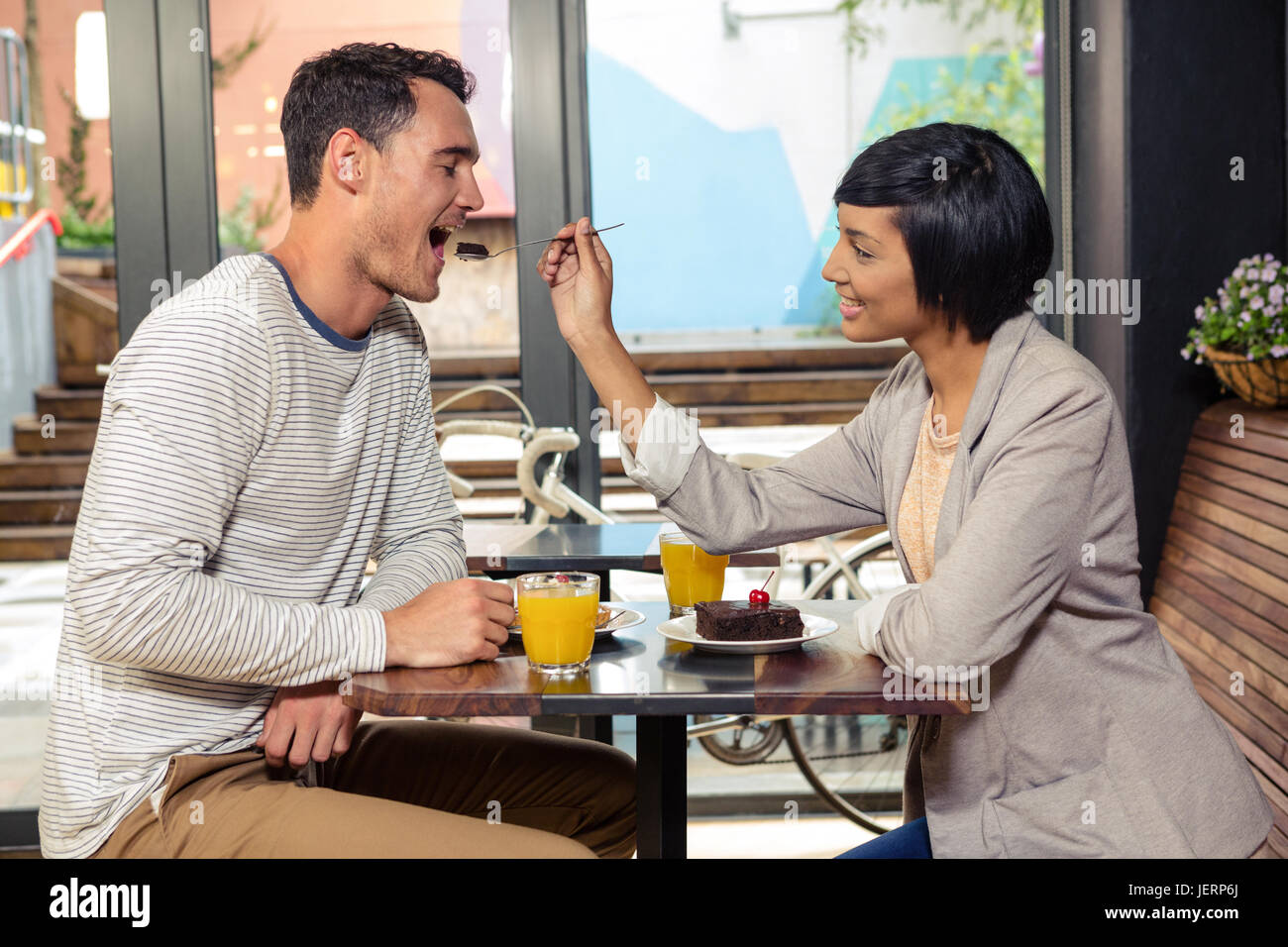 Girlfriend feeding her boyfriend Stock Photo - Alamy