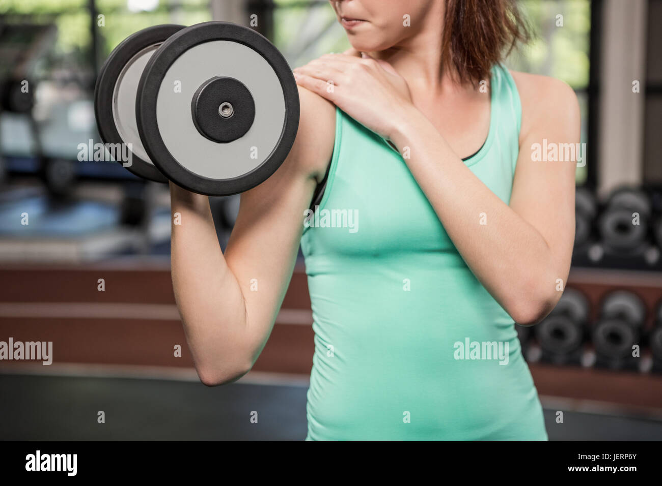 Woman lifting dumbbell Stock Photo - Alamy