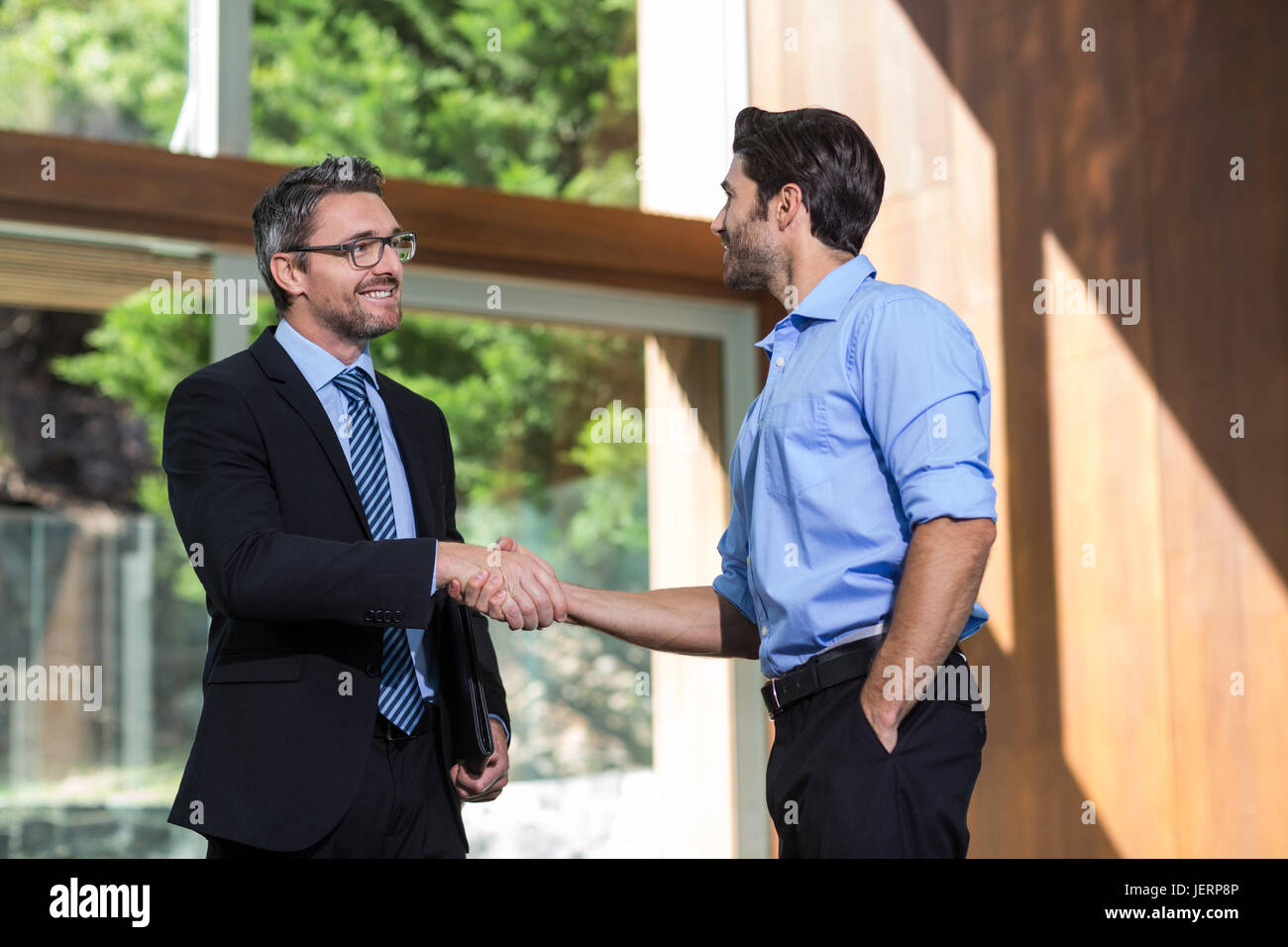 Hand shaking file folder hi-res stock photography and images - Alamy