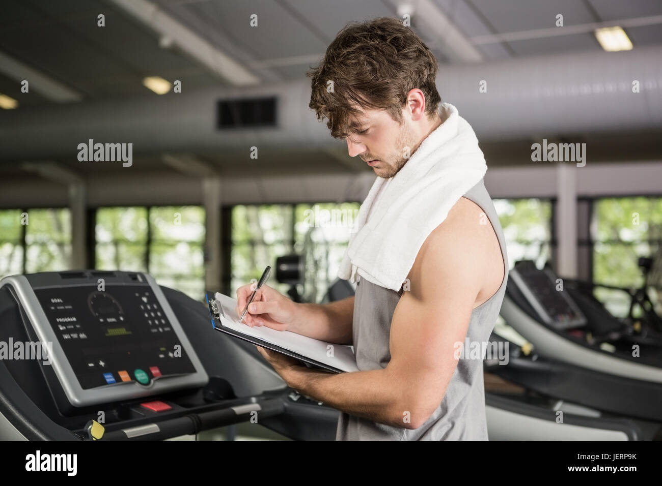 Gym instructor writing on clipboard Stock Photo - Alamy