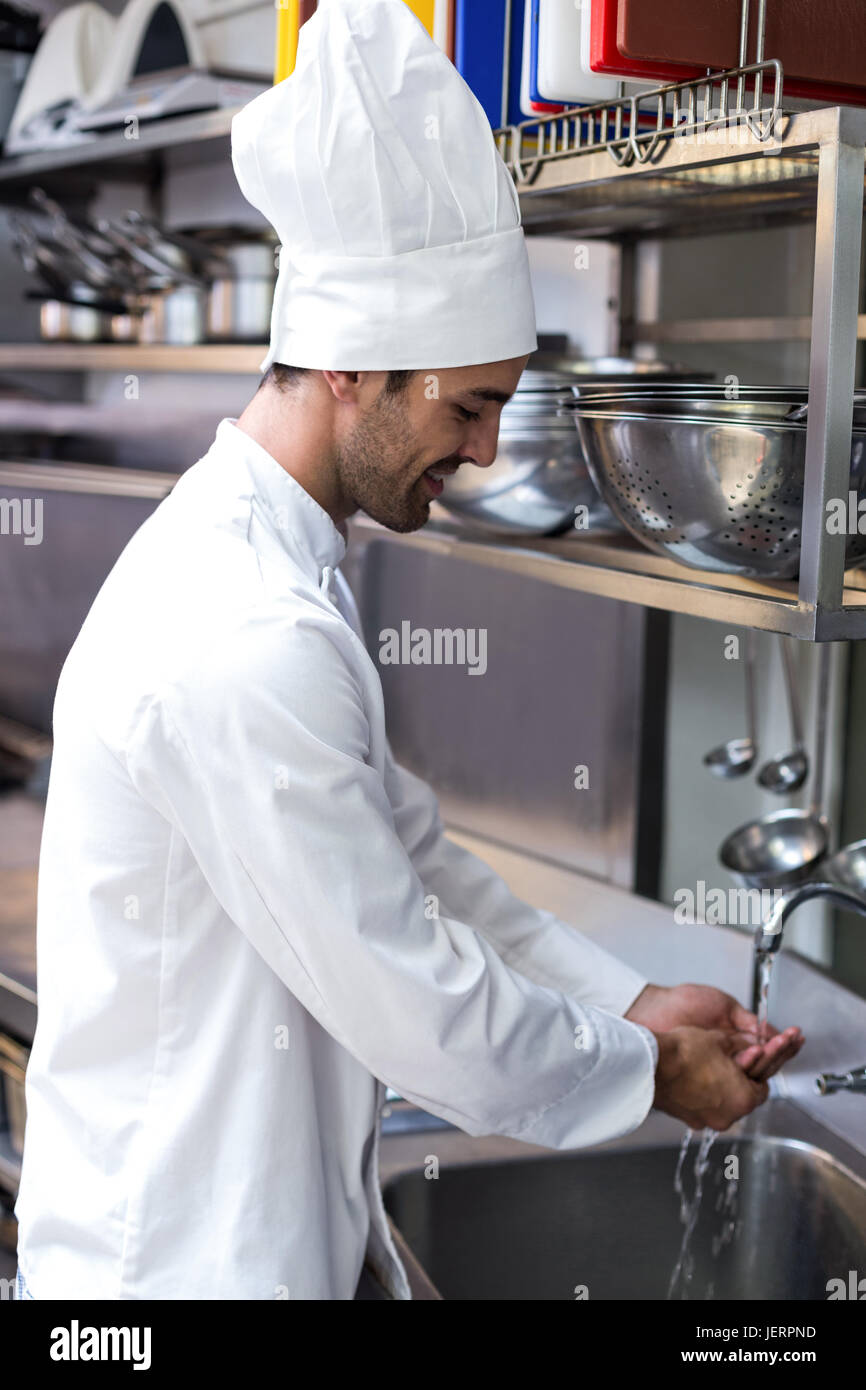 Handsome chef washing his hands Stock Photo - Alamy