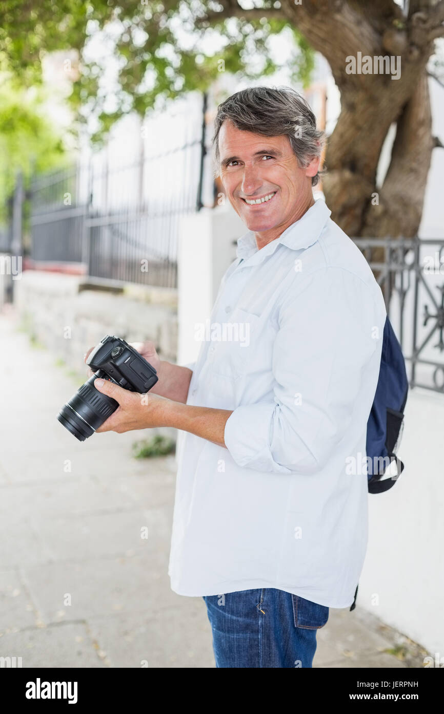 Portrait of happy man using camera Stock Photo - Alamy