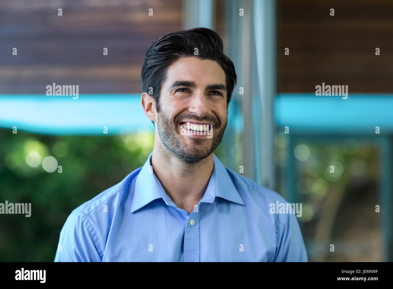Happy smart man looking away Stock Photo - Alamy