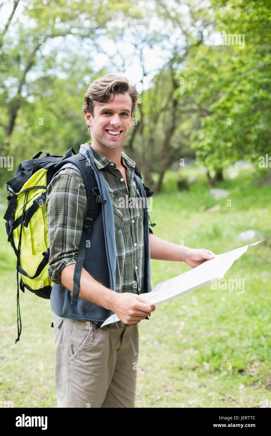 Portrait of smiling man holding map Stock Photo - Alamy