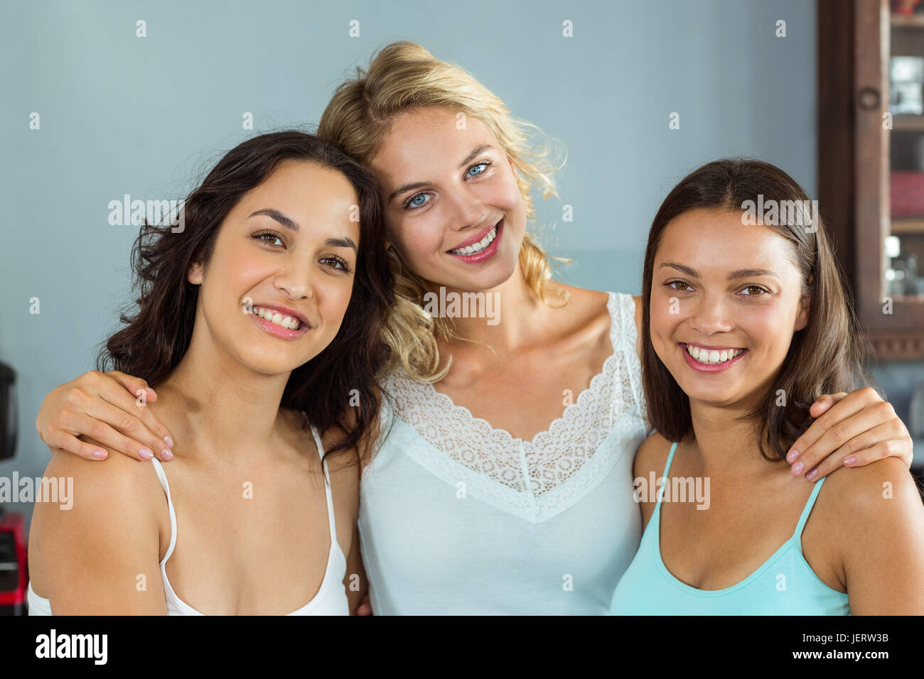 Beautiful young friends smiling at home Stock Photo - Alamy