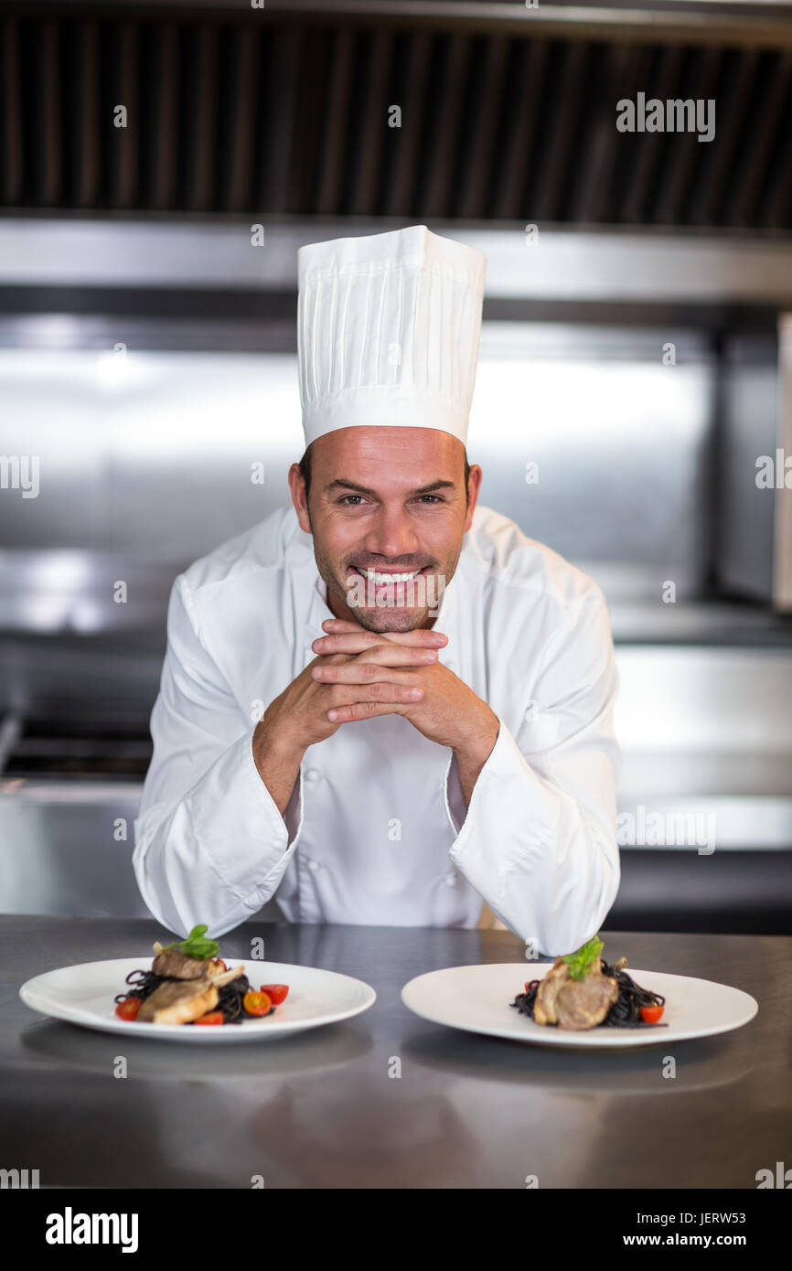 Portrait of smiling chef standing in kitchen Stock Photo - Alamy